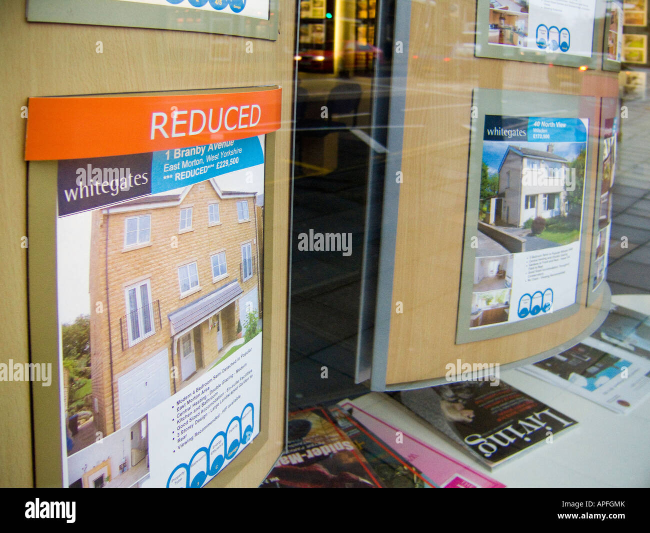 Estate agents window showing property prices being reduced Stock Photo ...