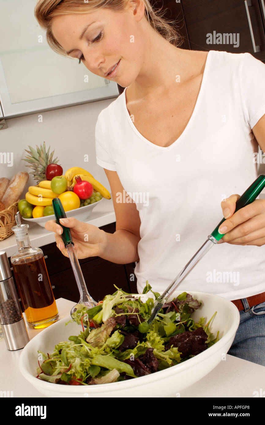WOMAN IN KITCHEN MAKING SALAD Stock Photo - Alamy