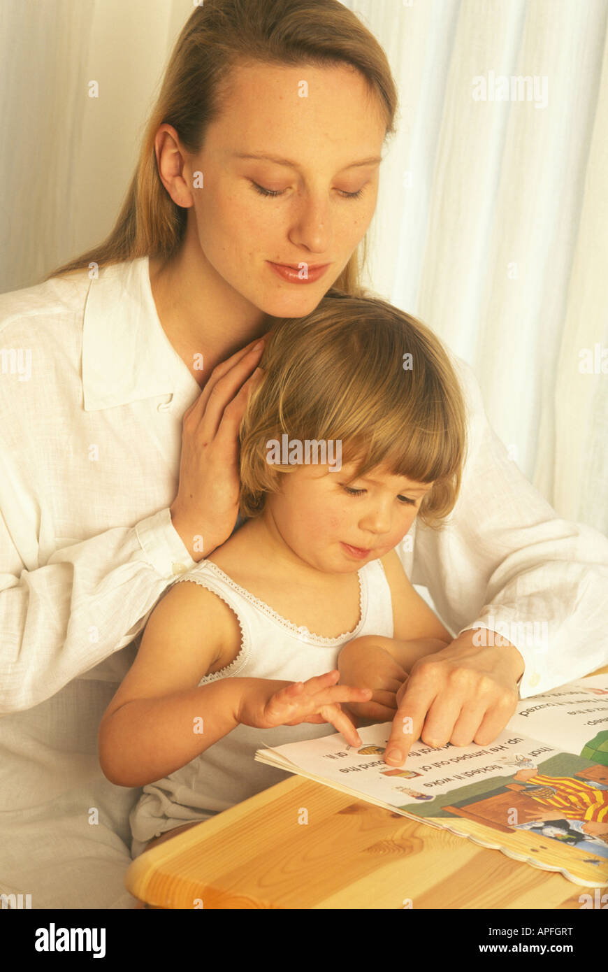 mother and child reading together Stock Photo - Alamy