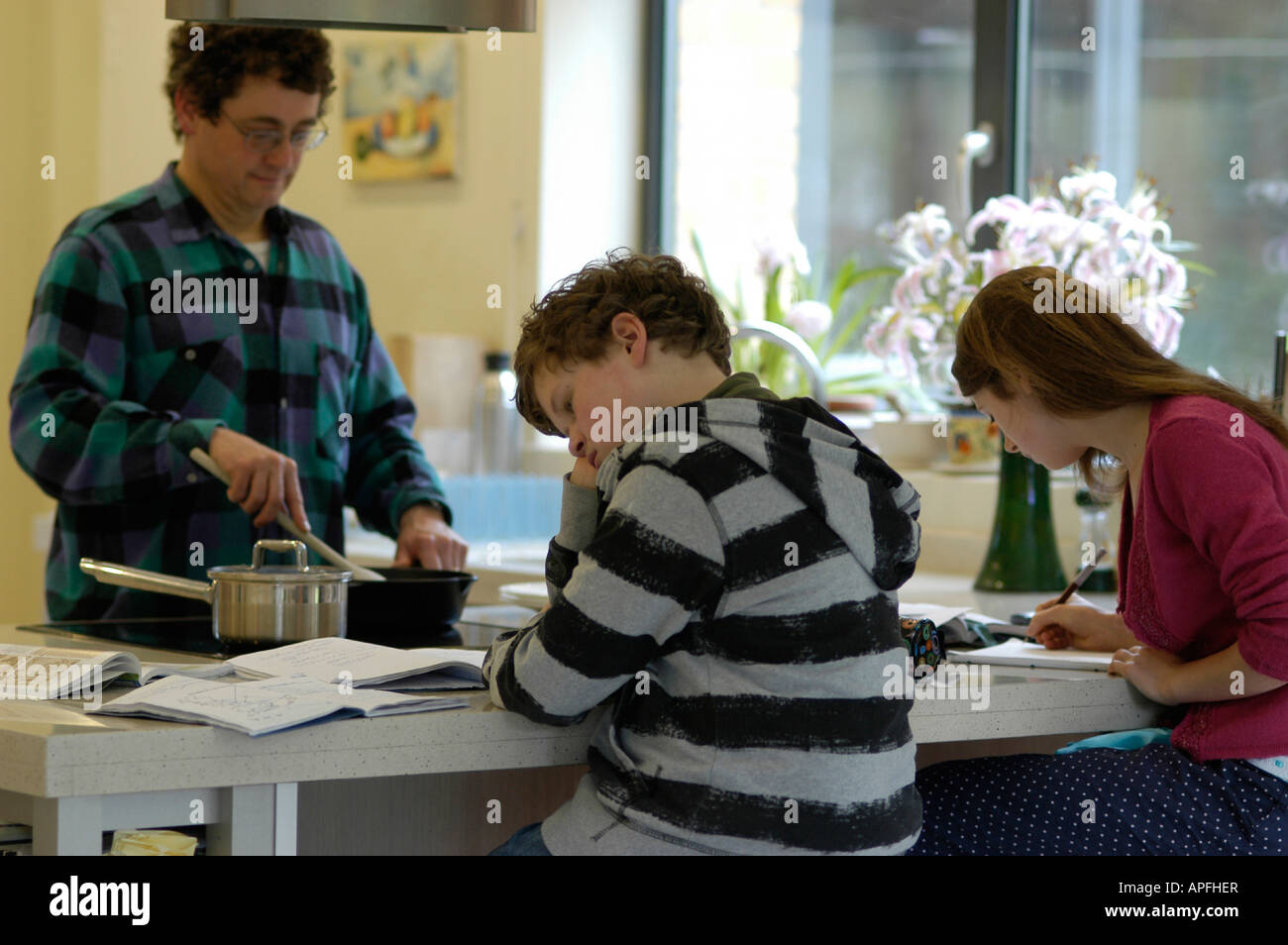 father cooking and helping children with homework Stock Photo - Alamy