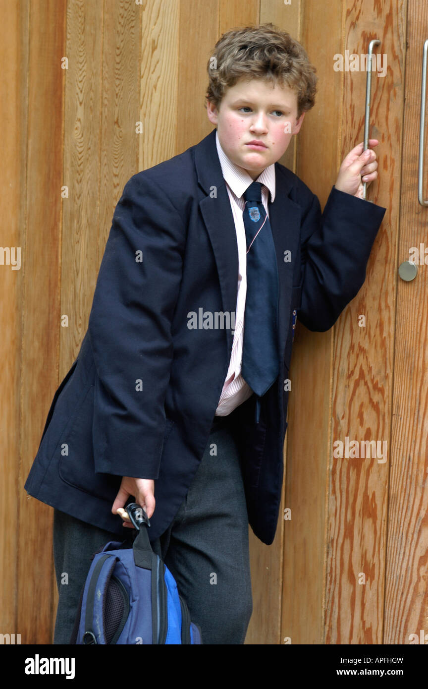boy looking miserable in school uniform Stock Photo - Alamy