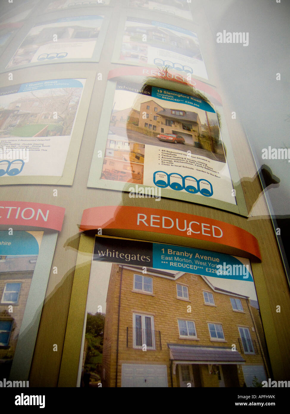 Estate agents window showing property prices being reduced Stock Photo ...