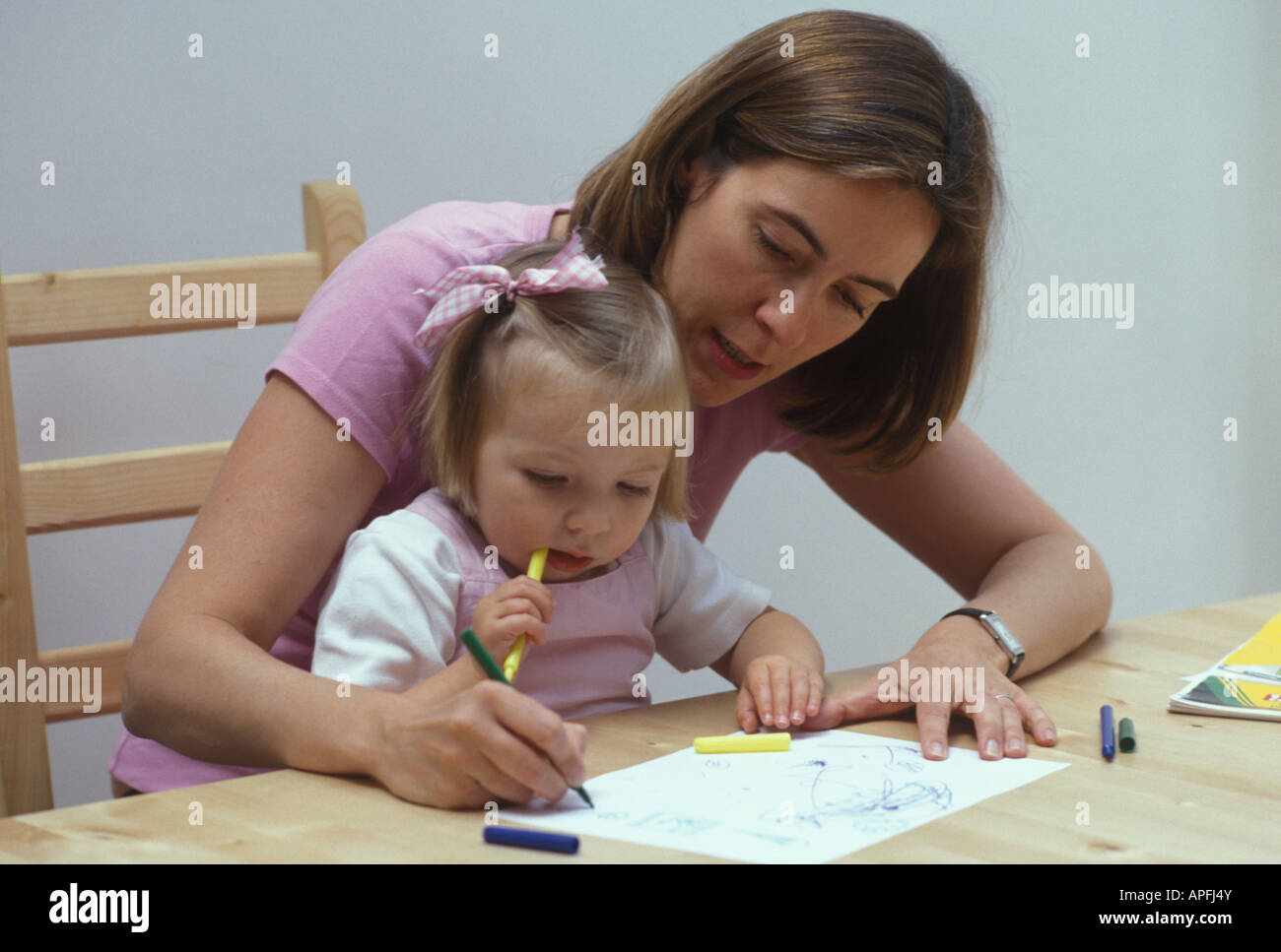 mother helping her child to draw Stock Photo - Alamy