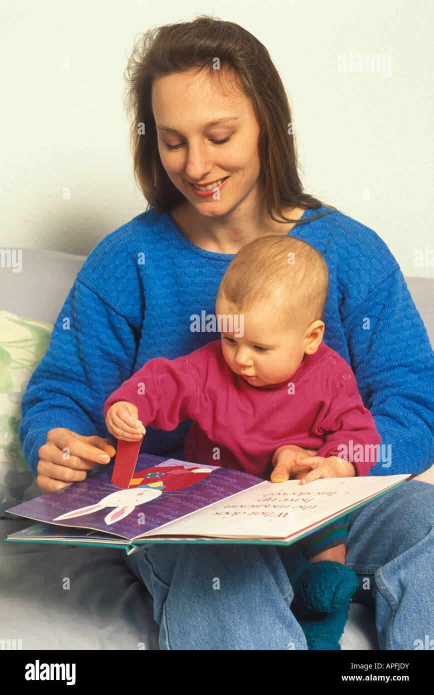 mother and baby reading a book together Stock Photo - Alamy