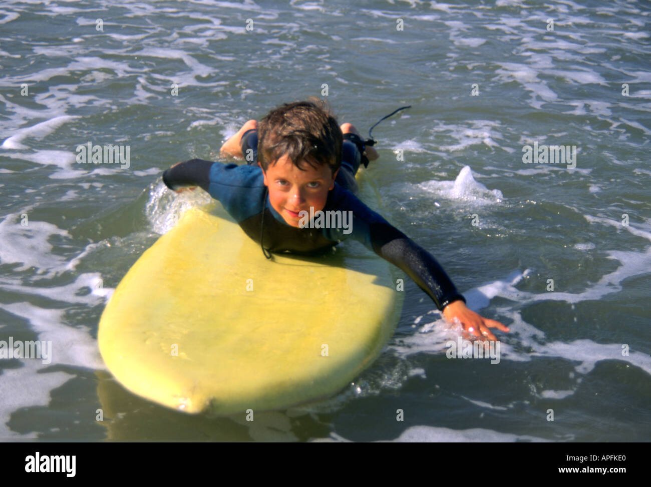 CHILD SURFING ACTION Stock Photo - Alamy