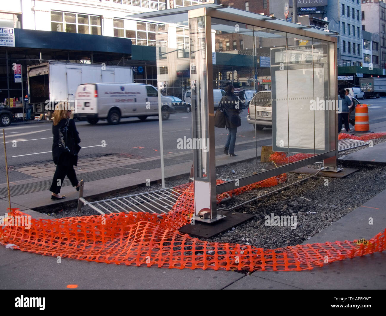 Pedestrians walk past the installation of a brand new bus Cemusa bus ...
