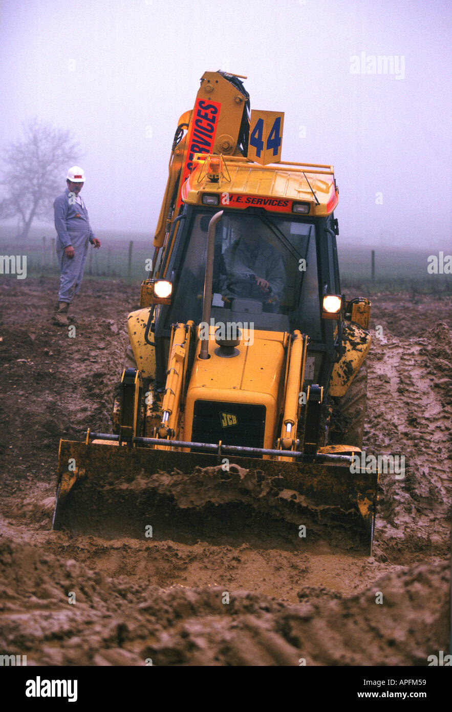 JCB digger moving mud, UK Stock Photo - Alamy
