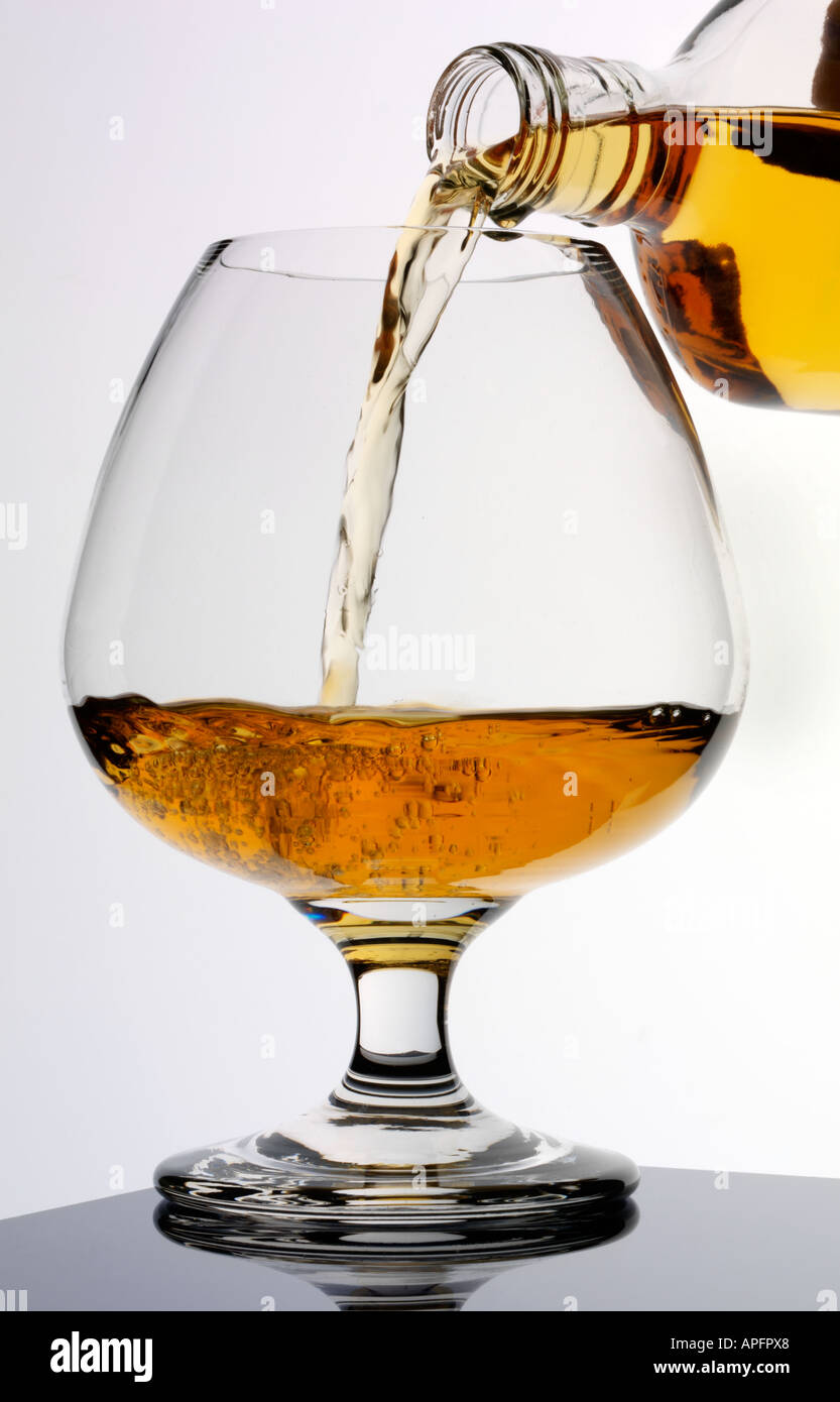 POURING GLASS OF BRANDY Stock Photo - Alamy