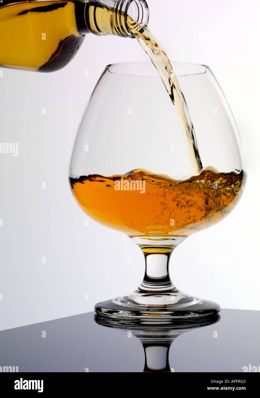 POURING GLASS OF BRANDY Stock Photo - Alamy