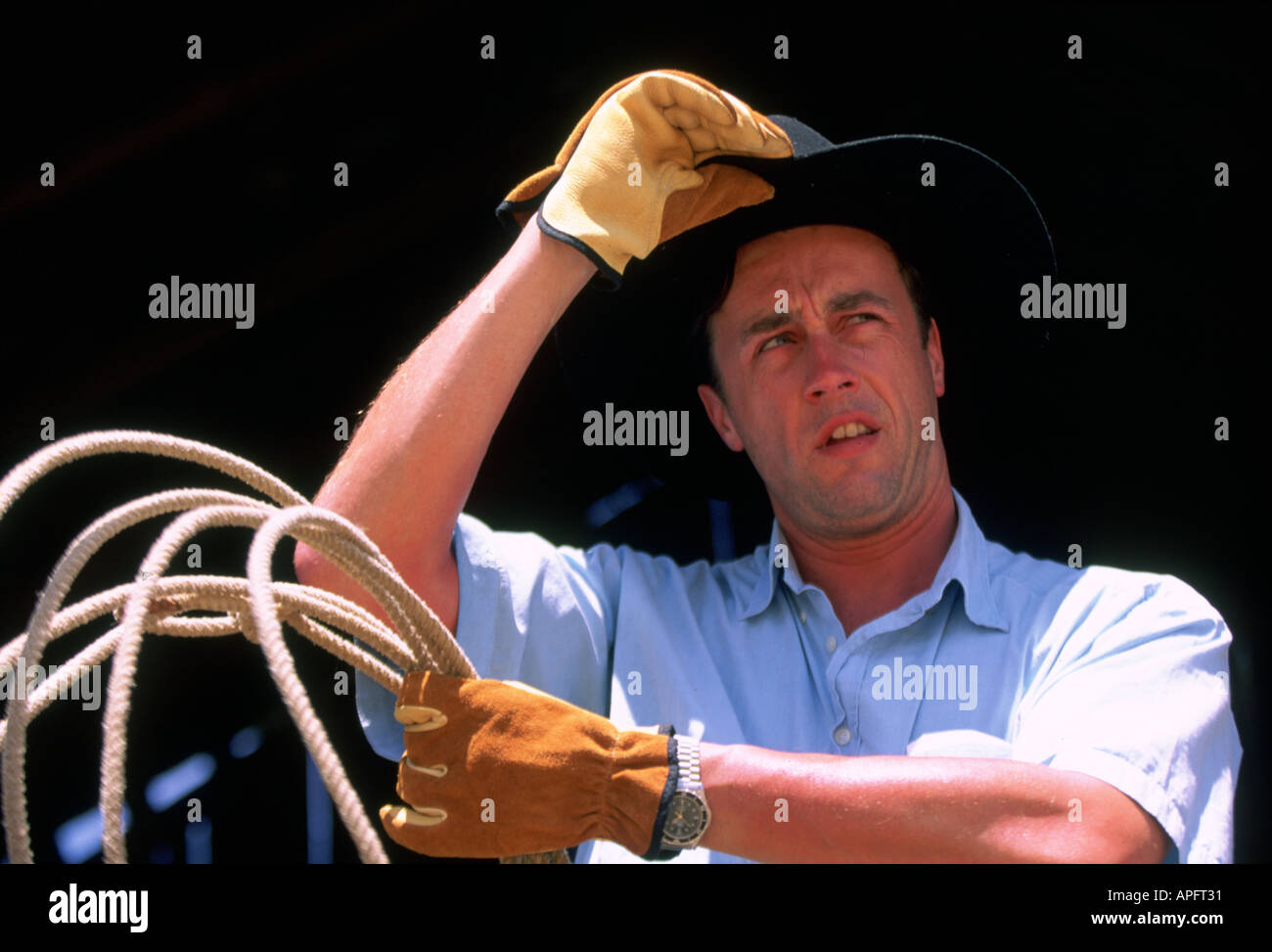 Cowboy holding lasso rope Stock Photo - Alamy