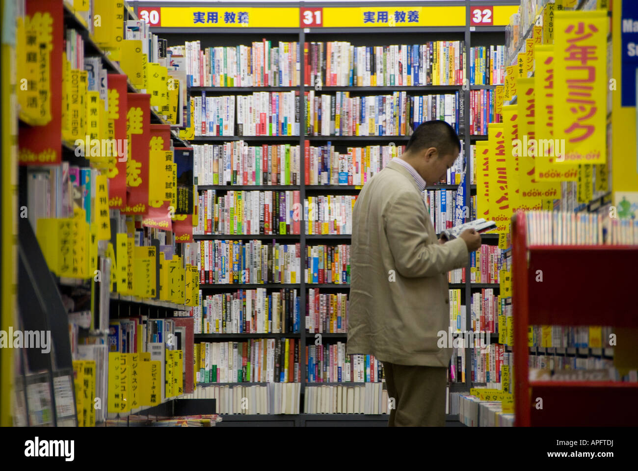 Customer reads in Japanese book store Book Off Pacific Square Shopping ...