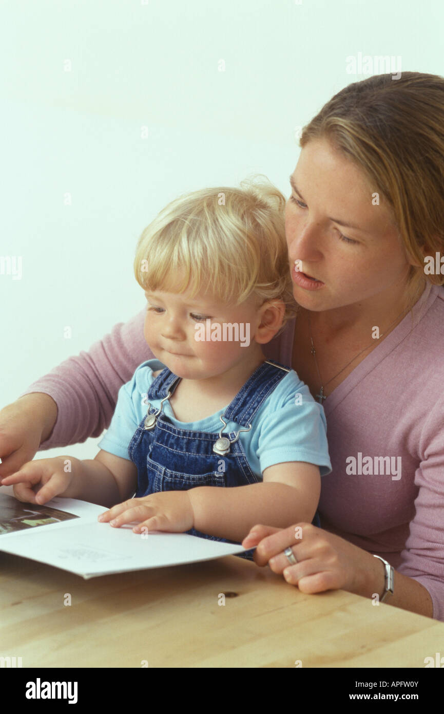 mother and toddler reading a book together Stock Photo - Alamy