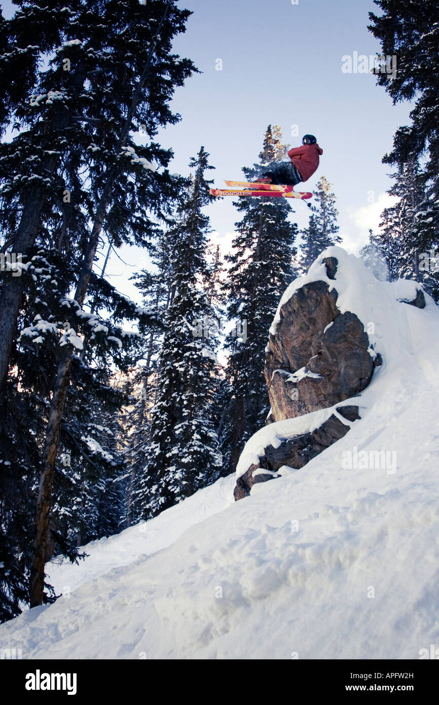 Skier jumping off rock Stock Photo - Alamy