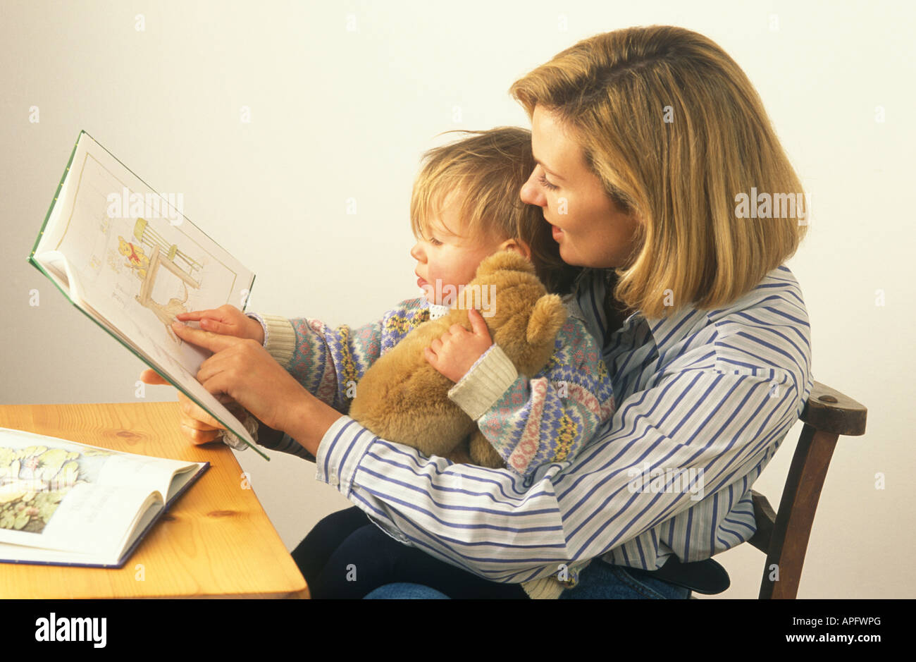 mother and toddler reading a book together Stock Photo - Alamy