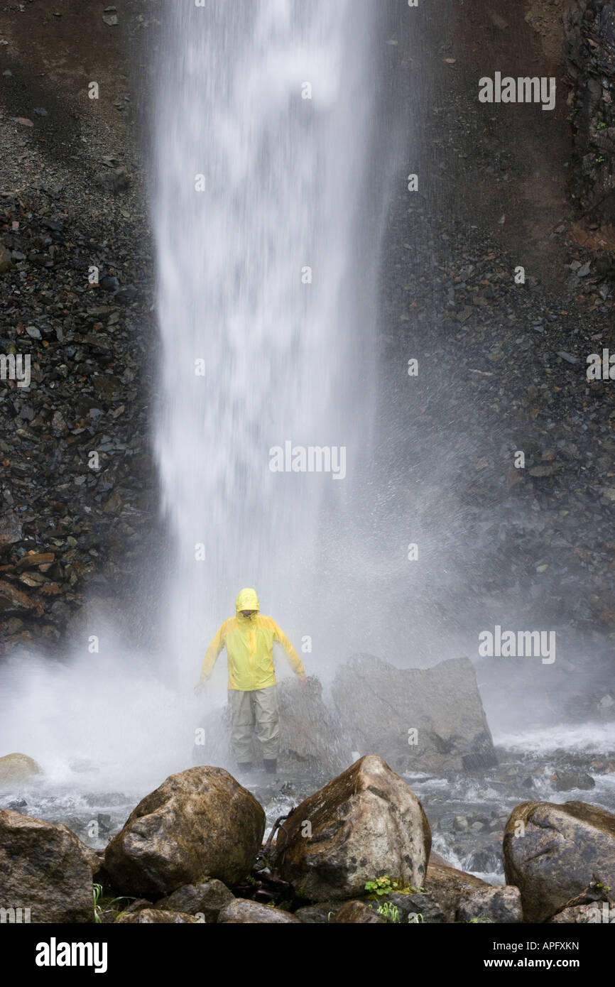 alaska lake clark national park woman in yellow jacket in waterfall ...