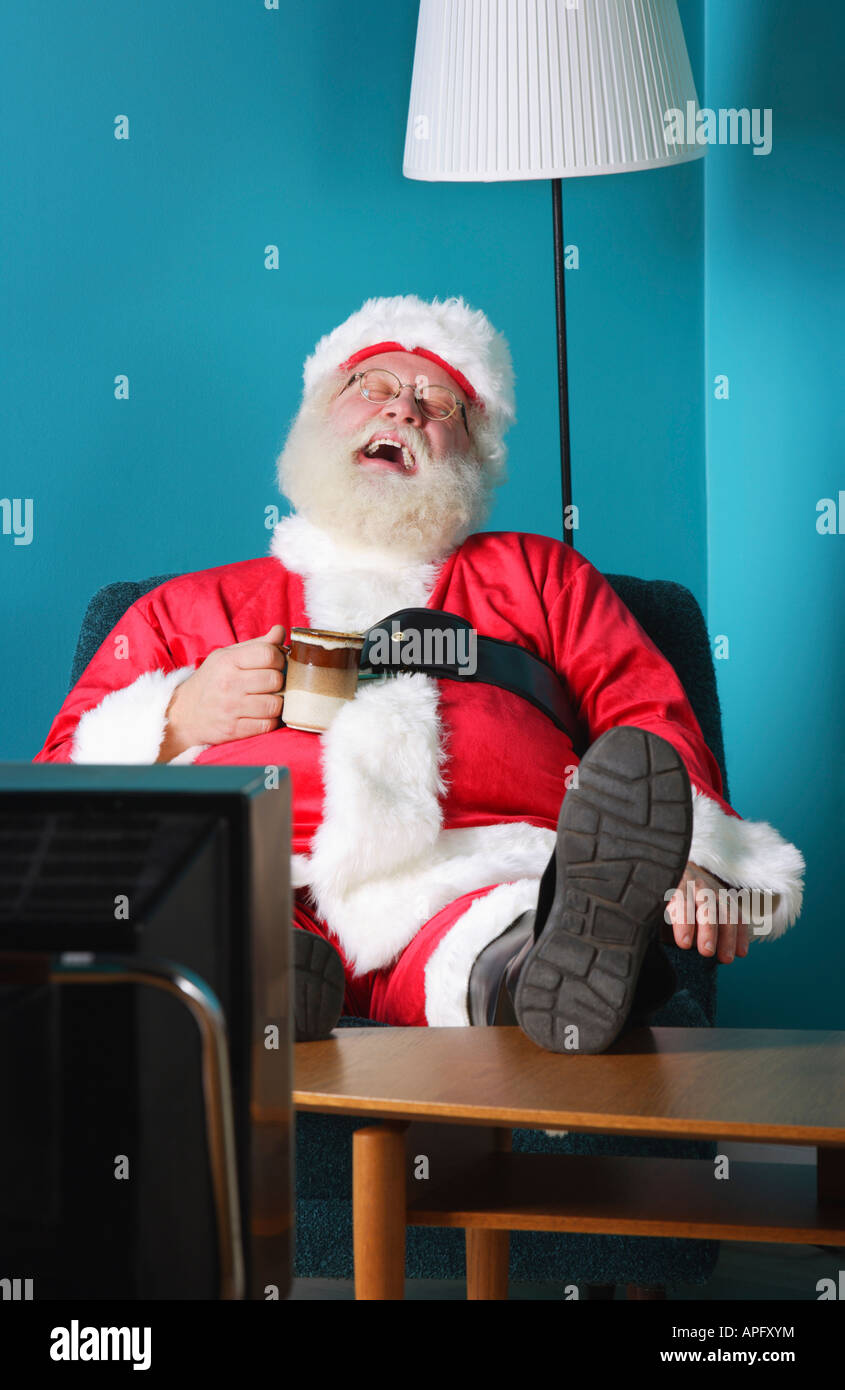 Santa Claus laughing and watching TV Stock Photo - Alamy