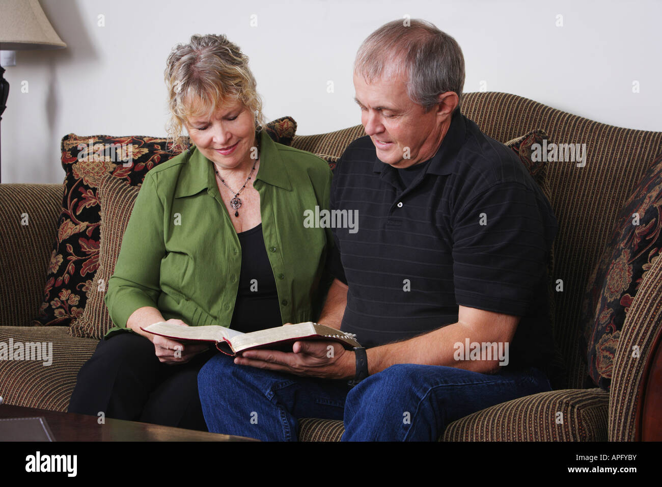 Couple reading together Stock Photo - Alamy
