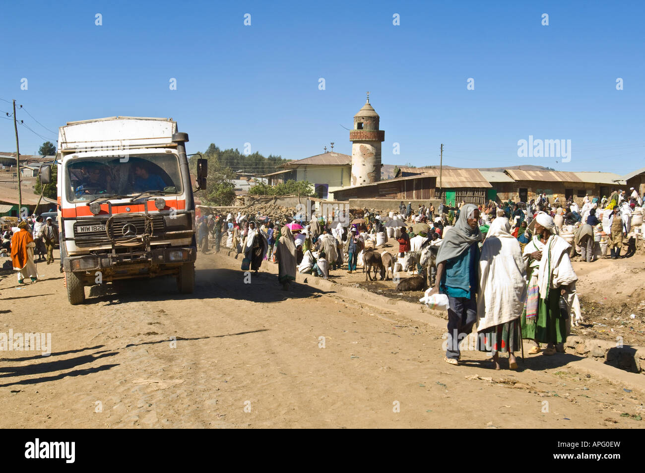 A tourist overland truck travelling through the main market in the town ...
