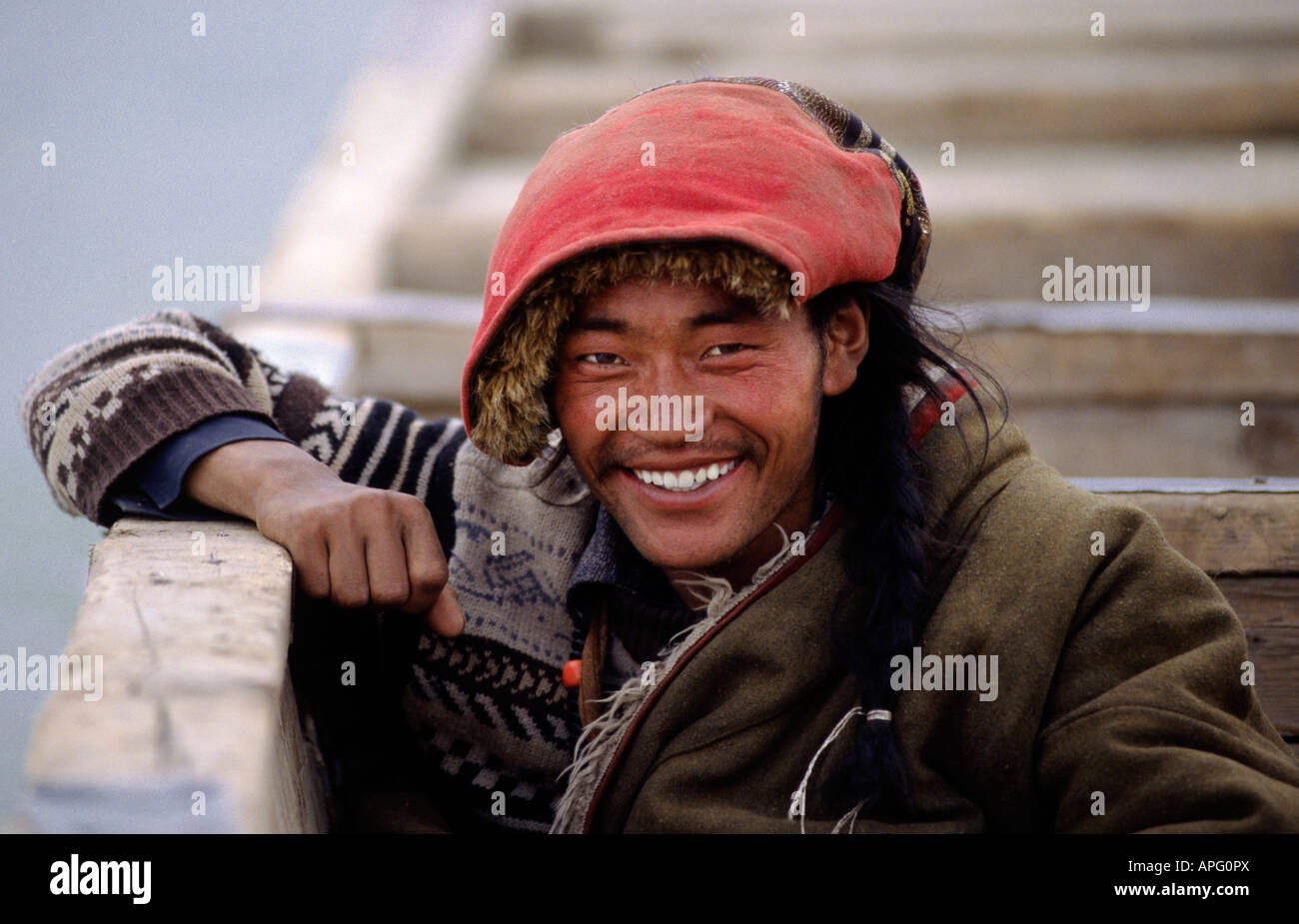 Handsome AMDO MAN sits in a boat as we cross the BRAMAHAPUTRA RIVER ...