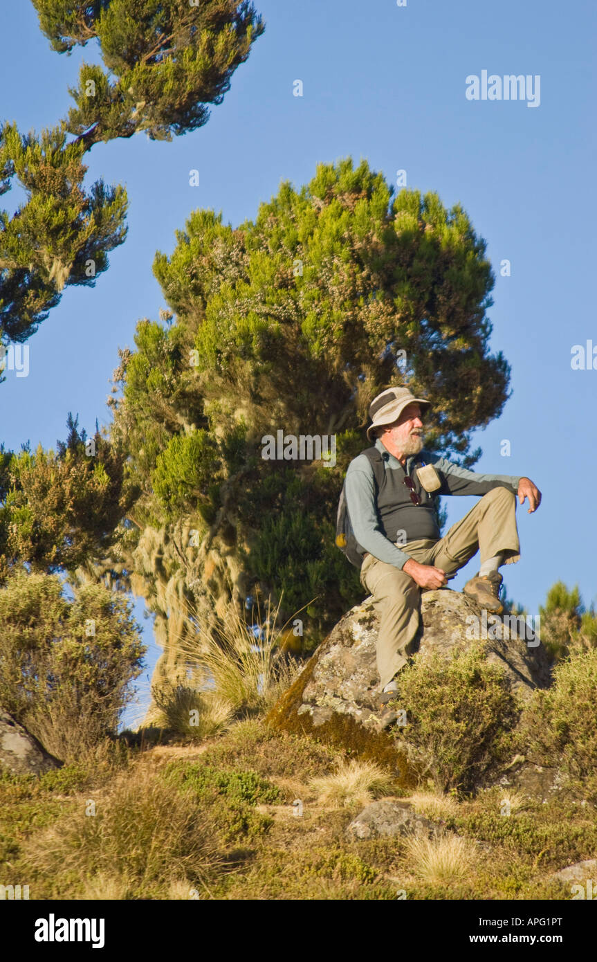 An elderly man tourist at rest while trekking hiking through the Semien ...