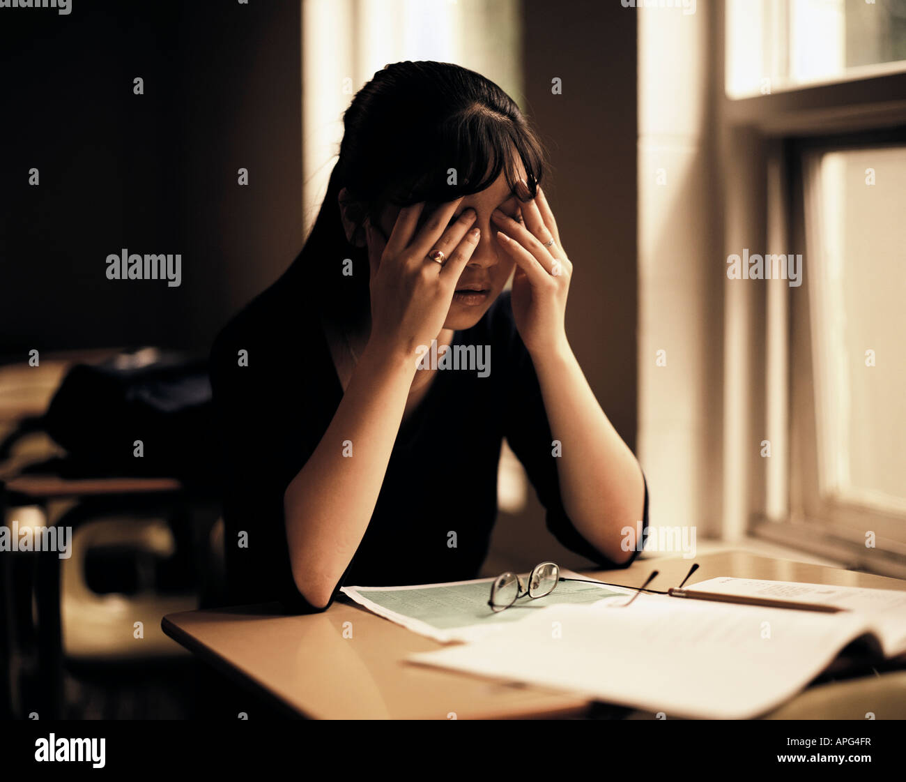 Girl taking a break from homework Stock Photo - Alamy
