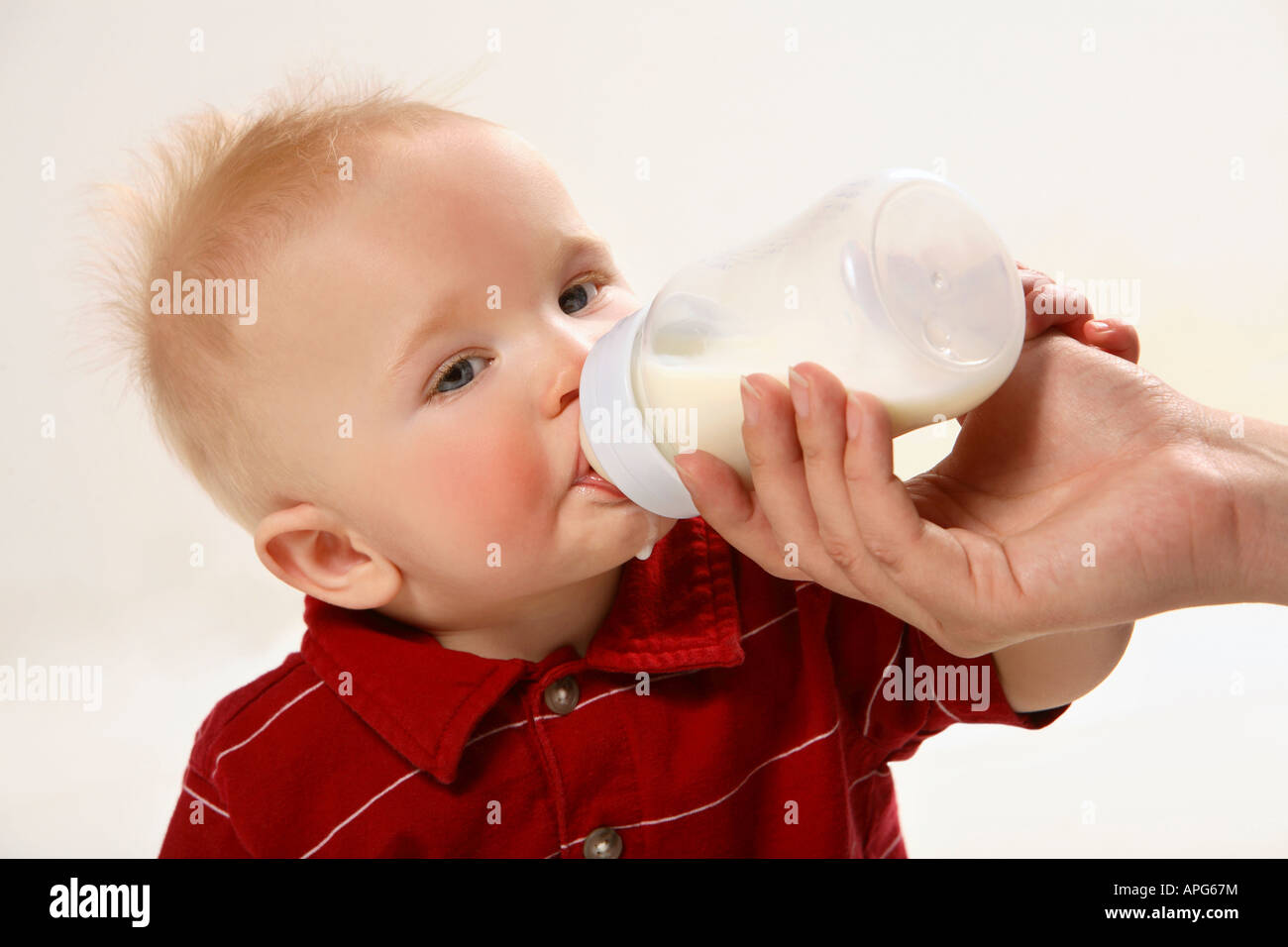 Baby boy drinking from a bottle Stock Photo - Alamy