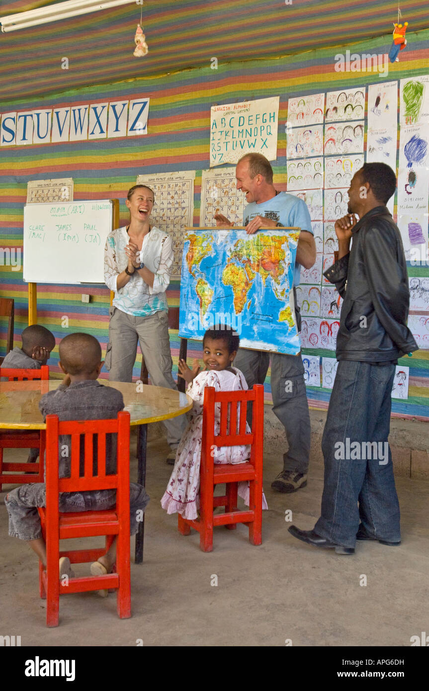The teachers smile and laugh in the classroom of a charity run school ...