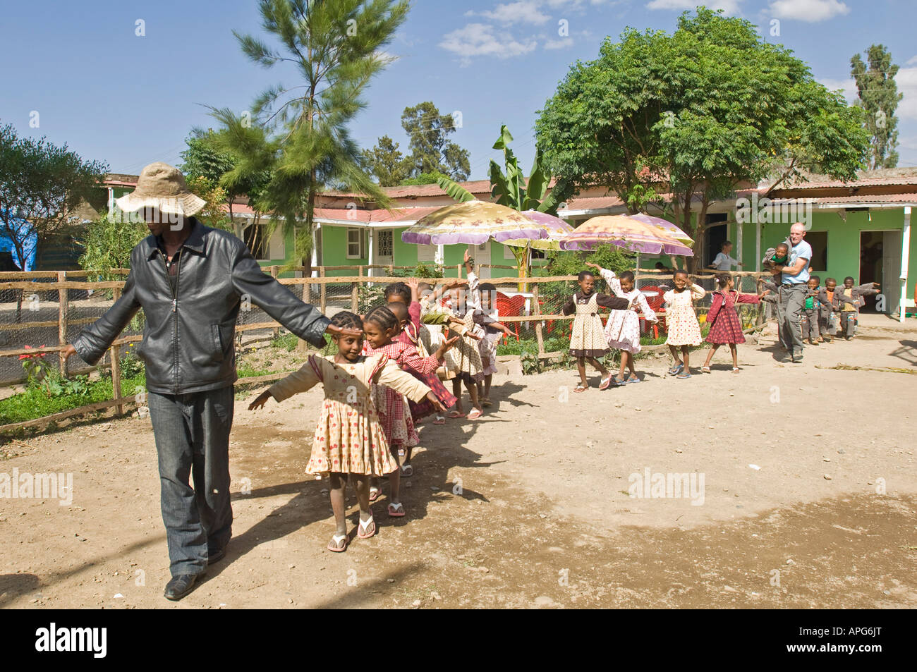 Children playing games in the playground of a charity run school Stock ...