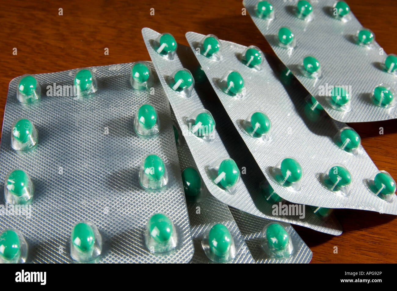 Green medical pills packed in foil Stock Photo - Alamy
