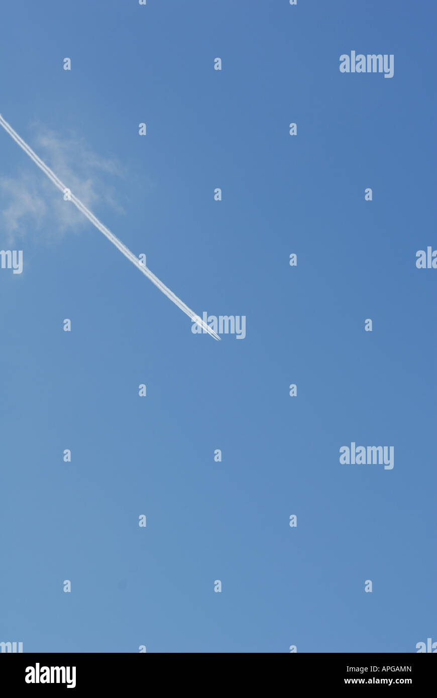 Jet contrail across a blue sky Stock Photo - Alamy