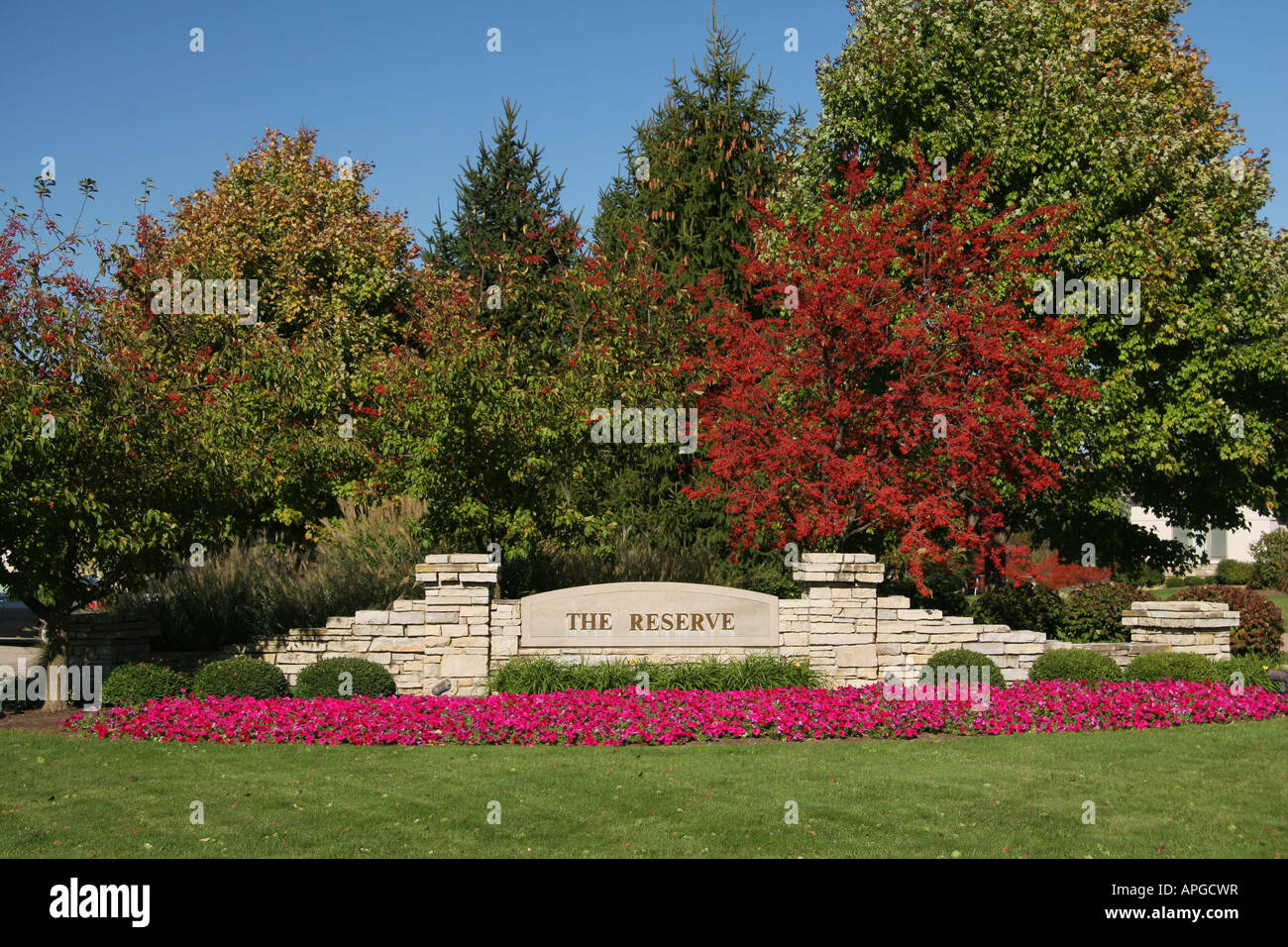 Stone Wall Sign Autumn colors Professional landscaping Stock Photo - Alamy