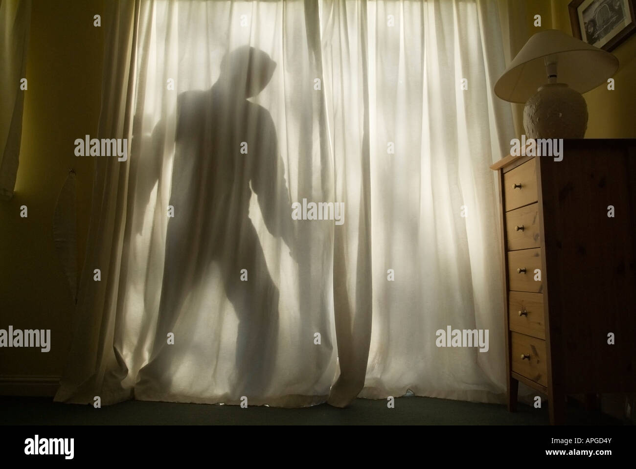 Man hiding behind curtains hi-res stock photography and images - Alamy