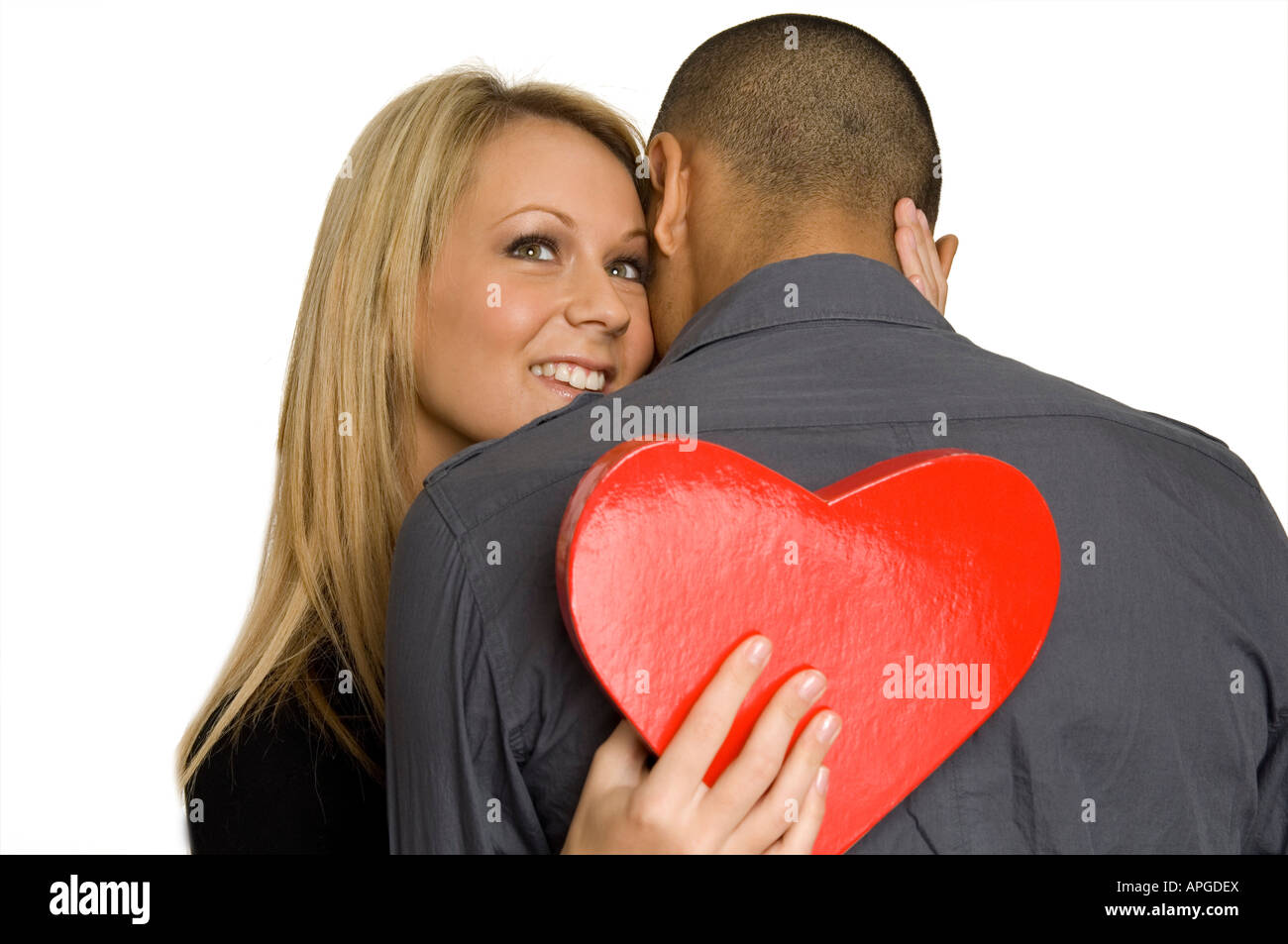 couple cuddling with a valentines day gift heart shaped box of ...