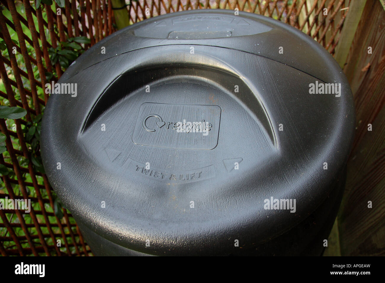 Recycle logo on the lid of a black plastic compost bin Stock Photo - Alamy