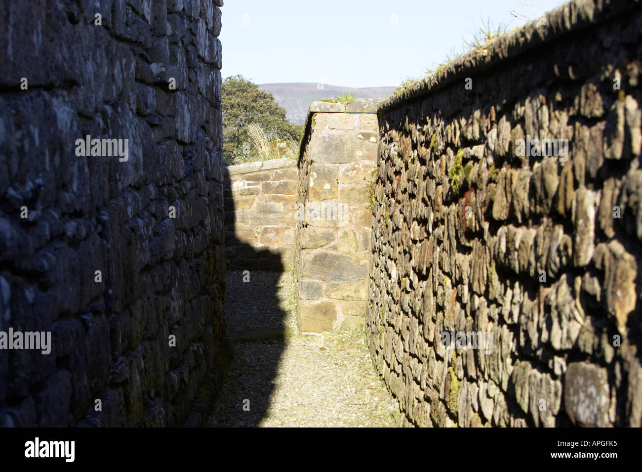 passageway between external stone walls of 12th century Banagher church ...
