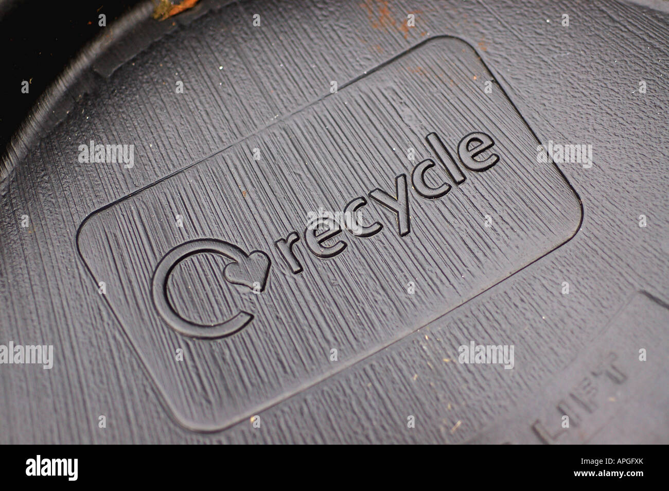 Recycle logo on the lid of a black plastic compost bin Stock Photo - Alamy