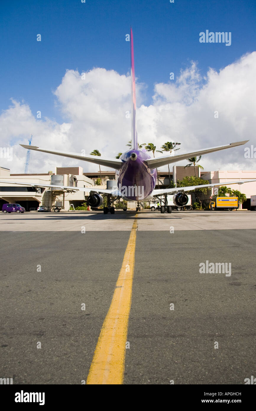 View from behind, passenger airplane on tarmac at gate sky with clouds ...