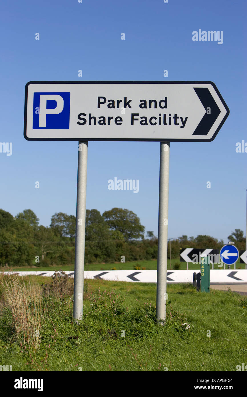 white black and blue park and share facility road sign against blue sky ...