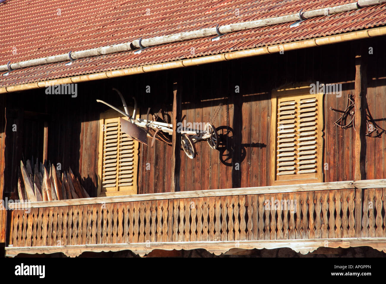 A Bavarian farm house balcony with farming equipment displayed Bavaria ...