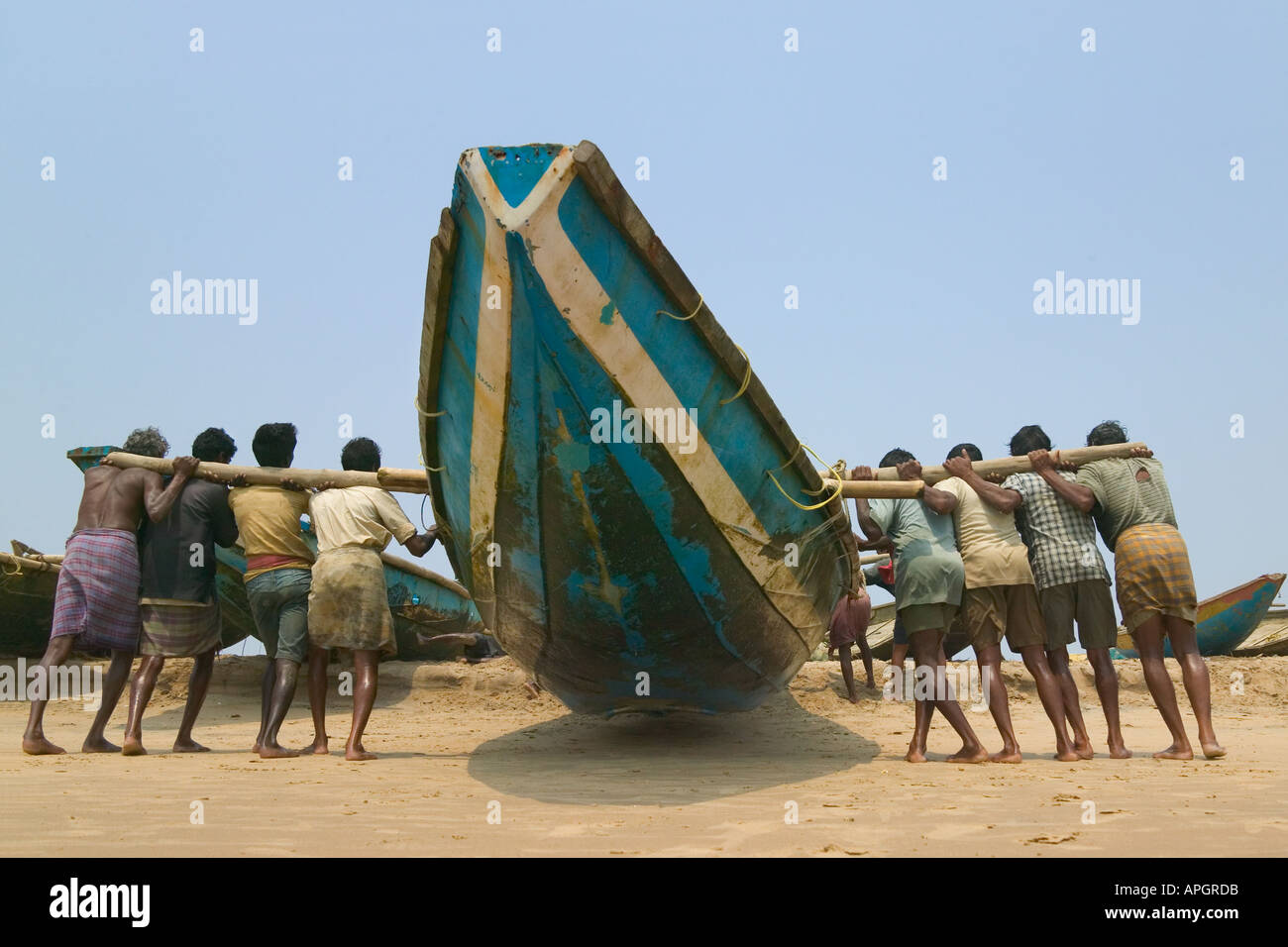 Fisherman carry boat on the beach Puri Orissa India Stock Photo - Alamy