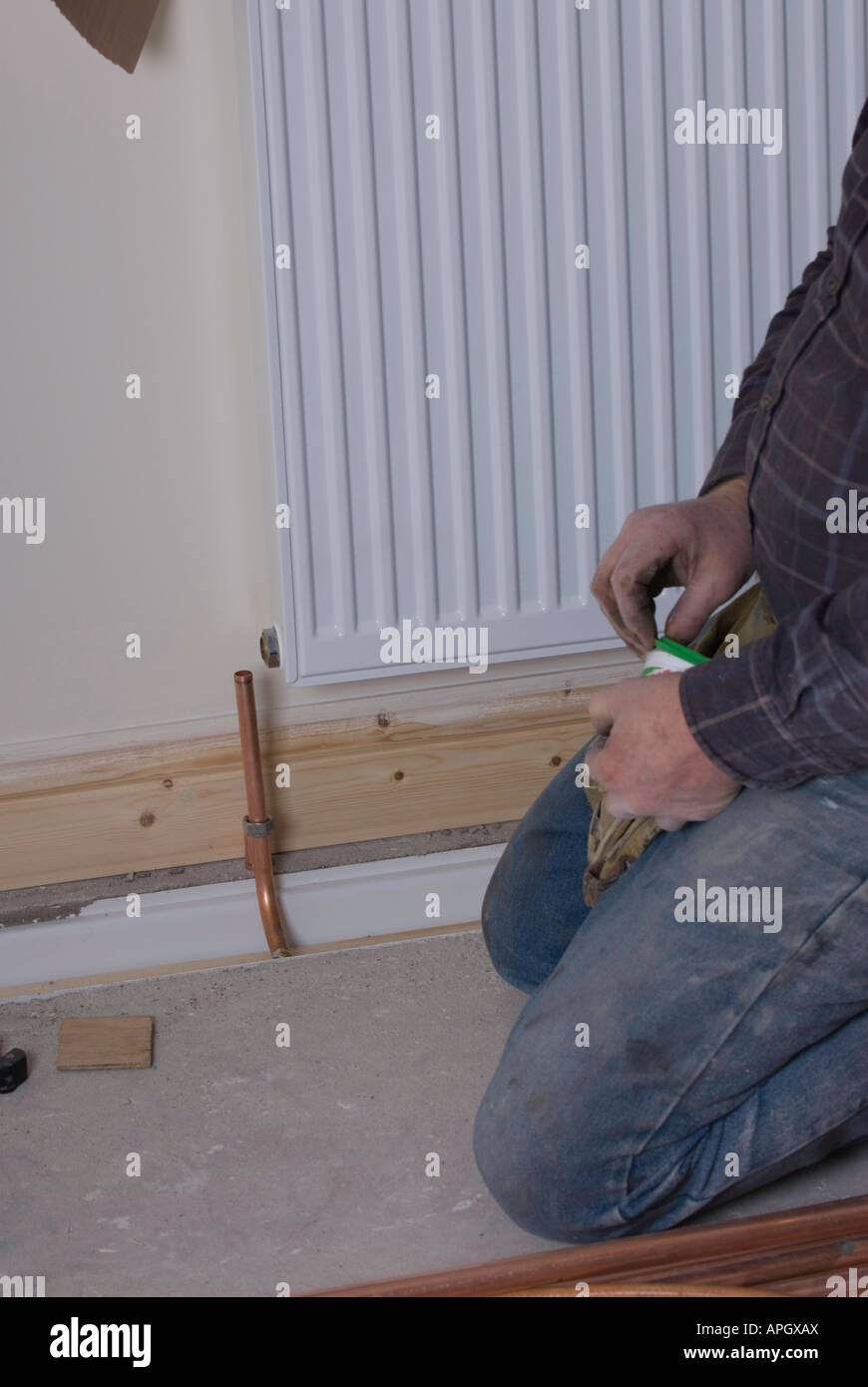 plumber fitting new radiator Stock Photo - Alamy