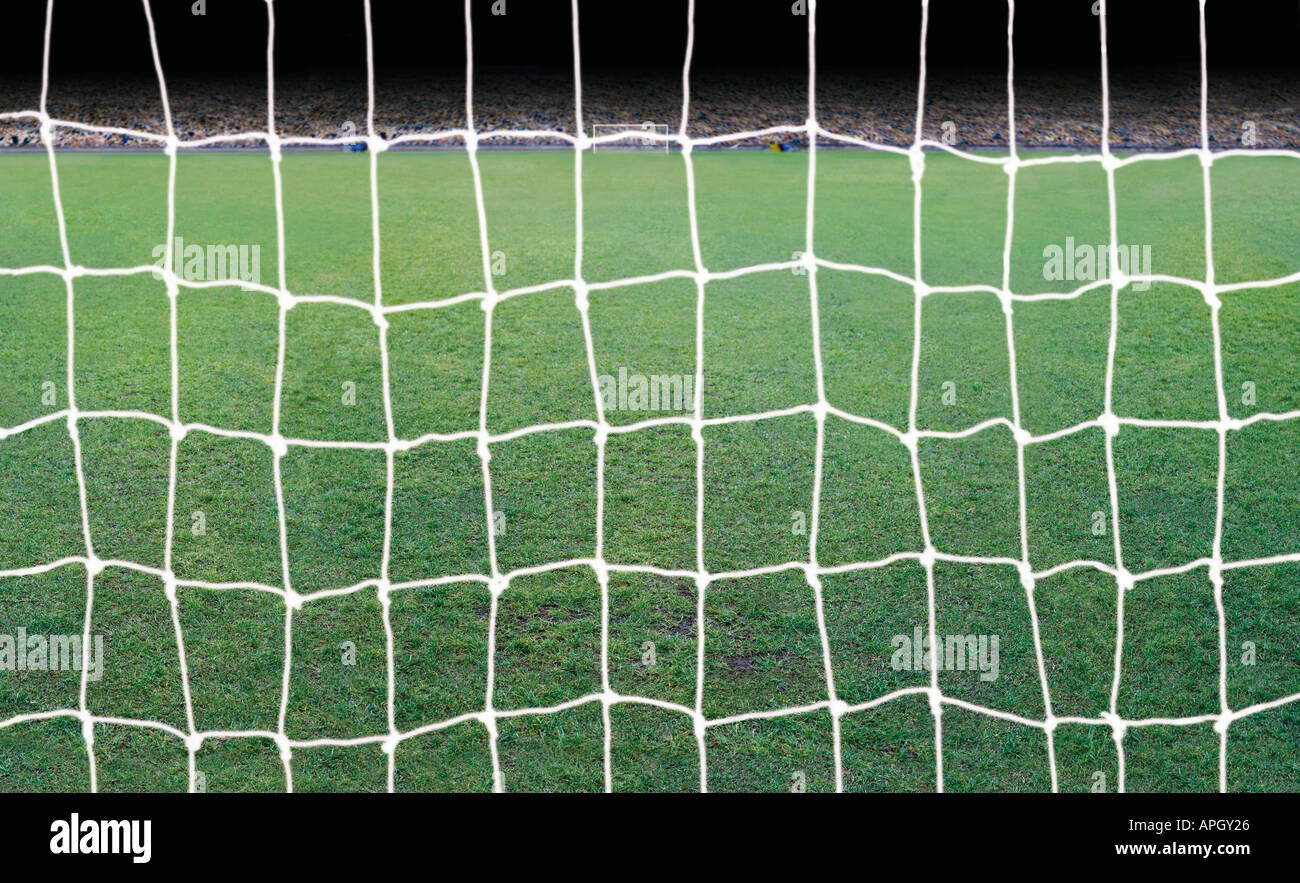 Goal net in front of football pitch Stock Photo - Alamy