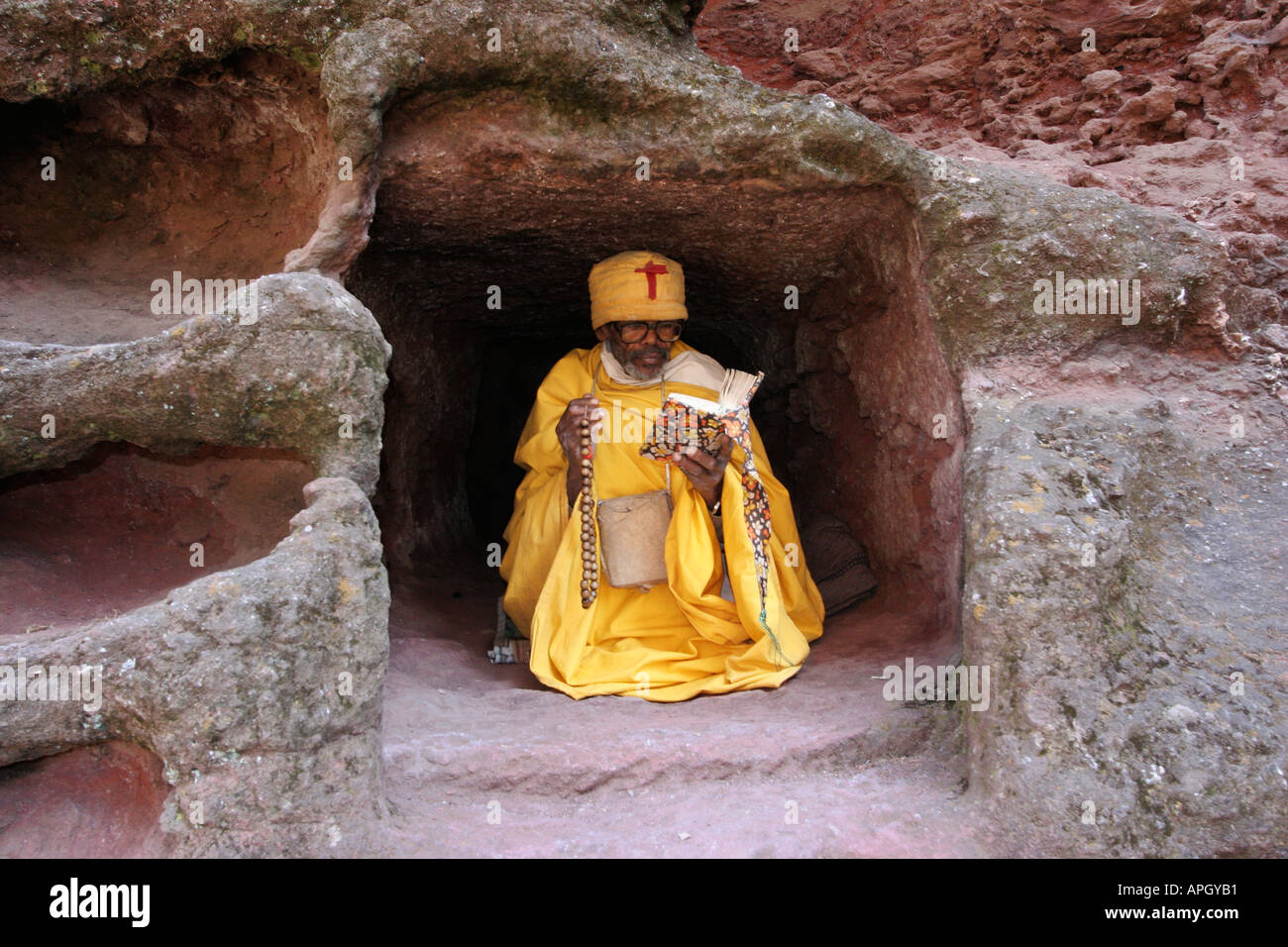 Ethiopian Orthodox Priest praying in Hermit Hole Lalibela Ethiopia ...