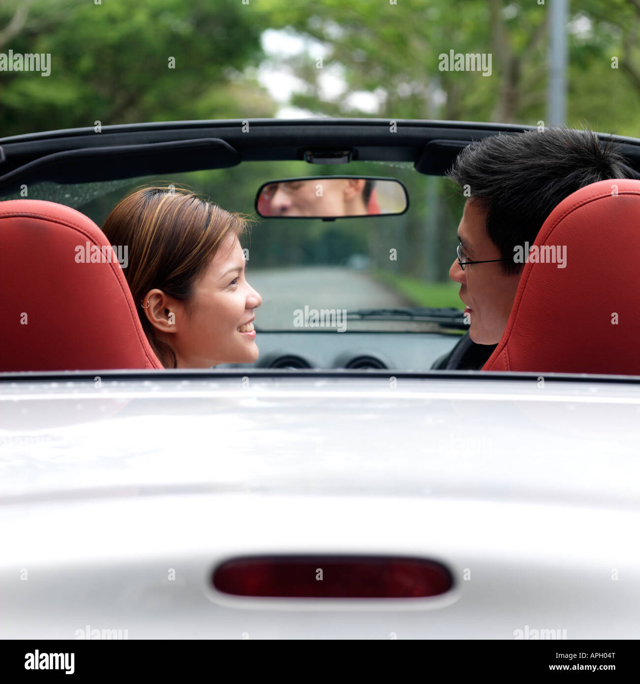 Couple in a convertible, rear view Stock Photo - Alamy