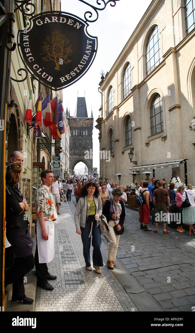 Prague street scene; A bustling Street in Prague, with Charles Bridge ...