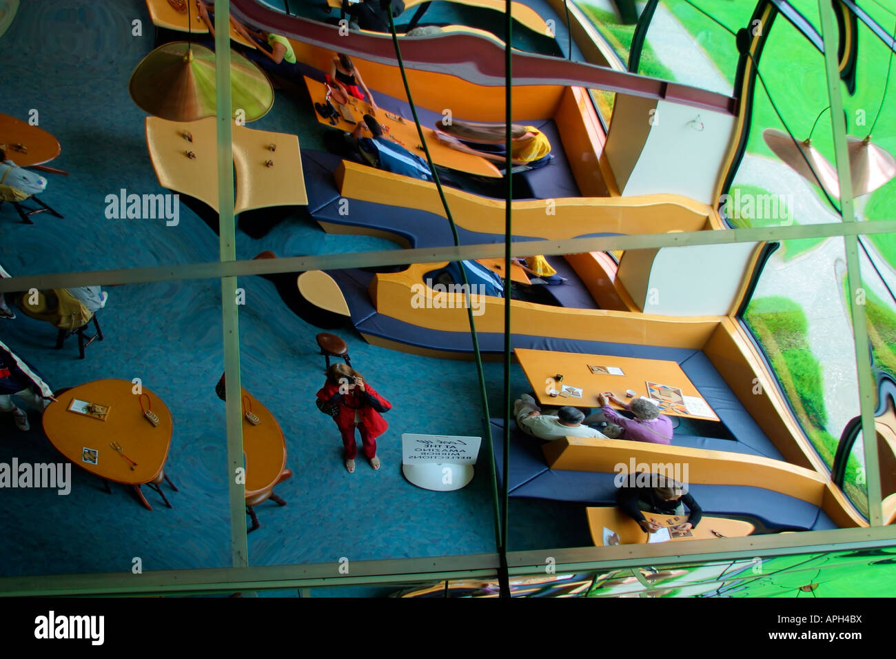 mirror image of photographer reflecting in bizarre distorted glass ...