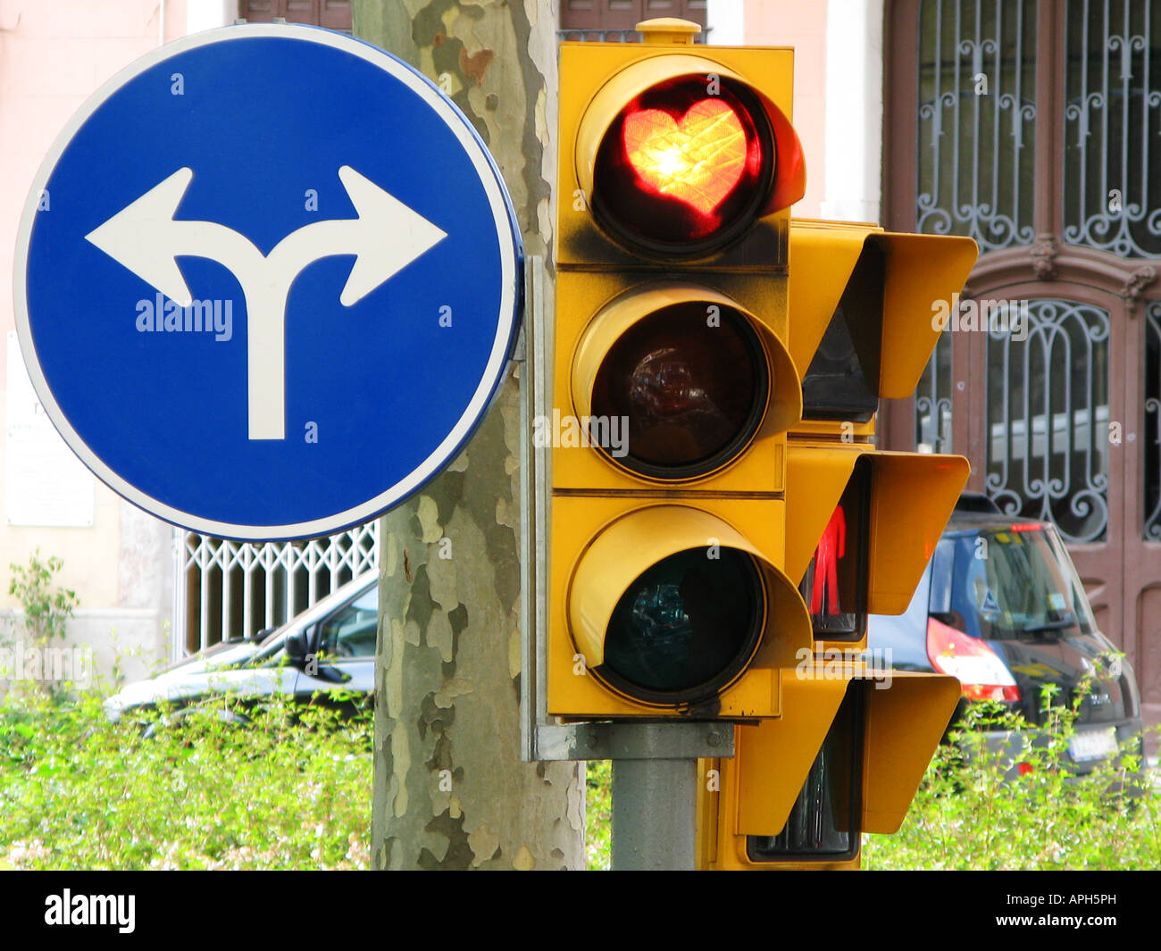 A set of Traffic lights and sign with a heart shaped red light in ...