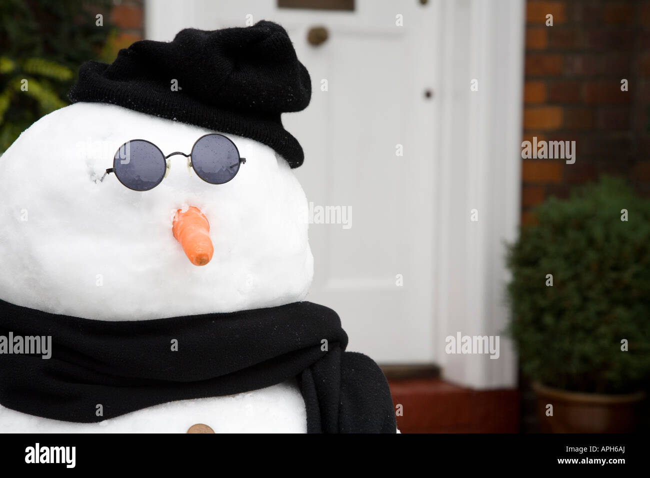Snowman outside the front door of a traditional house Stock Photo - Alamy