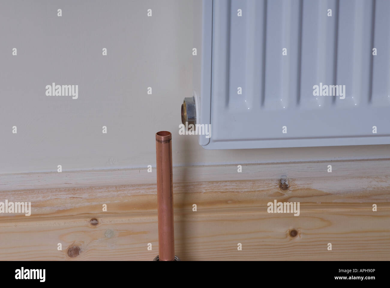 Copper piping to be fixed to new radiator Stock Photo - Alamy