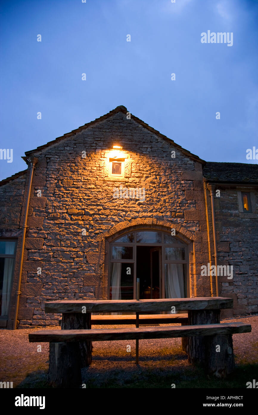 Converted Limestone Barn with Outdoor Light at Dusk Stock Photo - Alamy